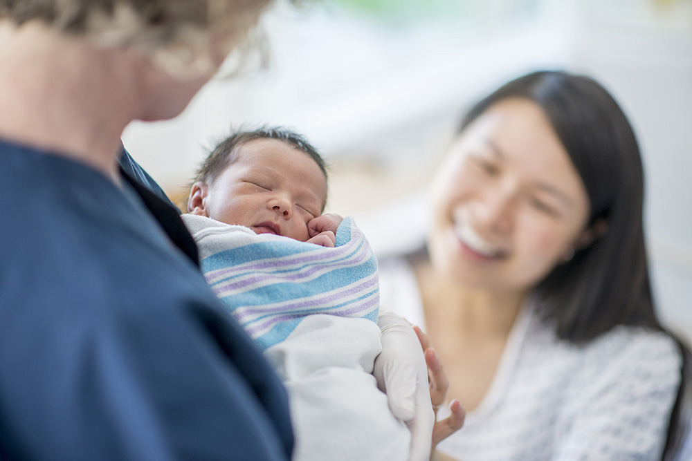 Nurse Holding A Newborn Bloodworks Northwest